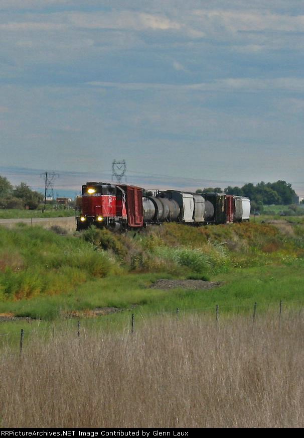 CBRW 2184 running long hood forward with 11 freight cars.
